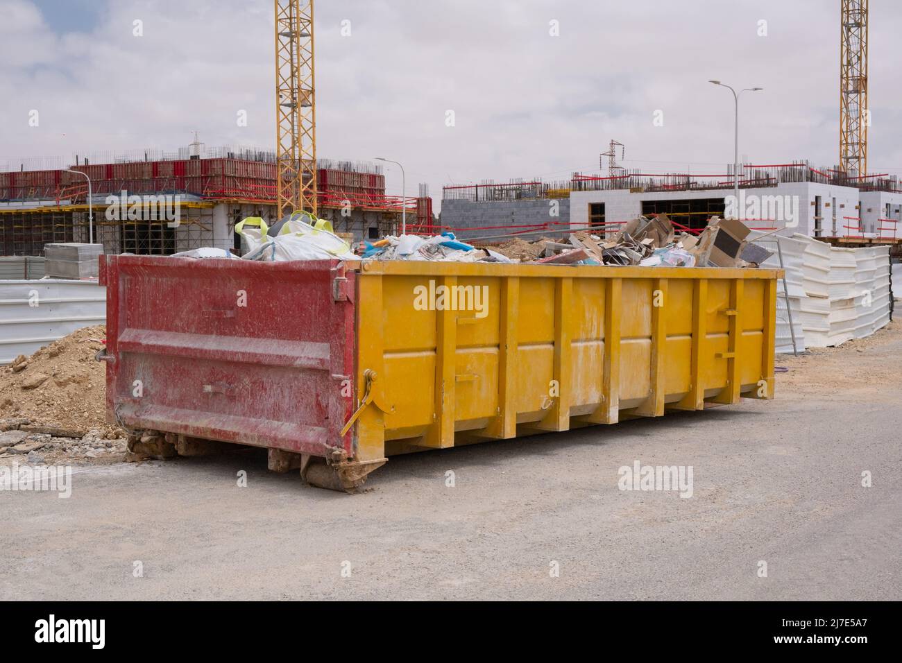 Construction waste in a Huge Overloaded dumpster. Waste metal tank ...