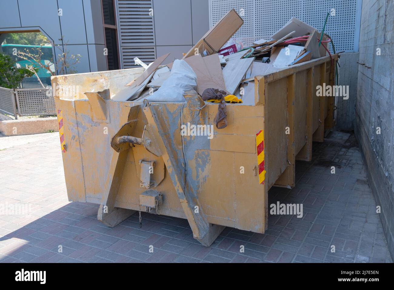 Construction waste in a Huge Overloaded dumpster. Waste metal tank ...