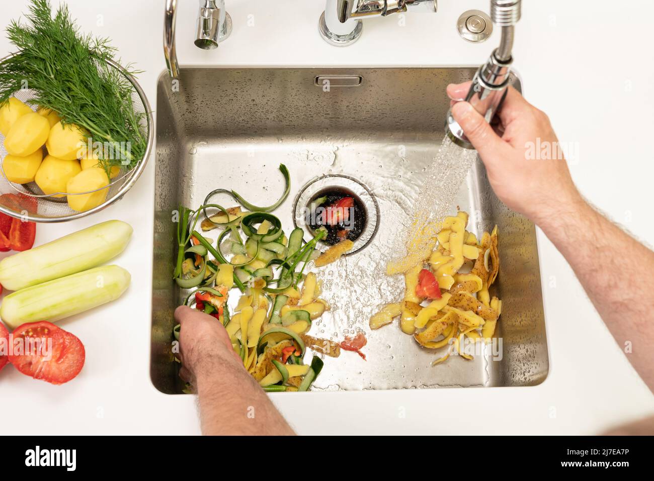 Food waste after peeling vegetables is destroyed using the Disposer ...