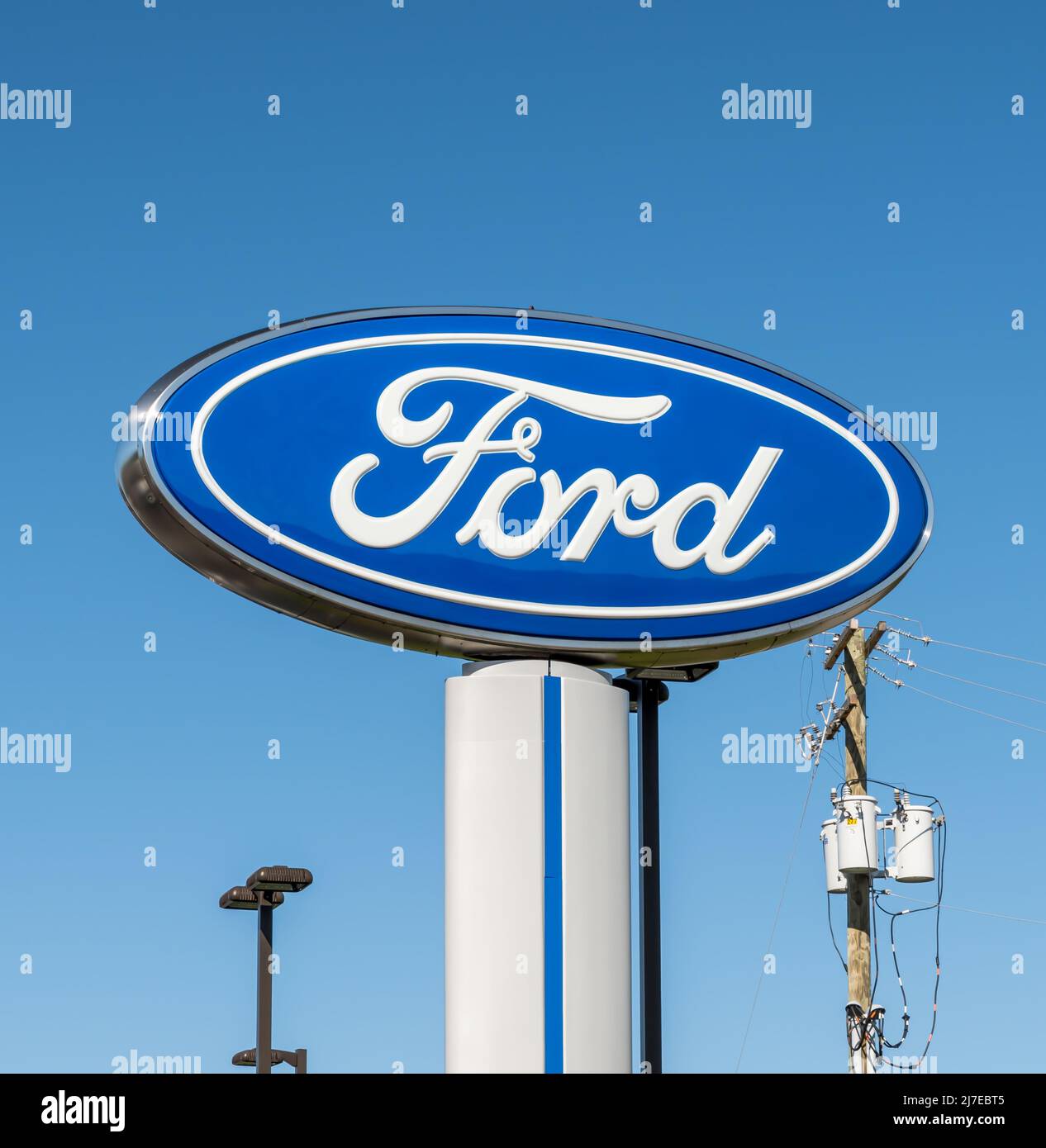 Isolated oval shaped Ford logo, the automobile, with a blue sky ...