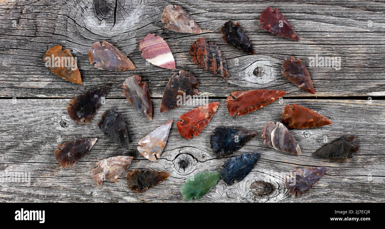 Collection of North America native American flint arrowheads on rustic ...