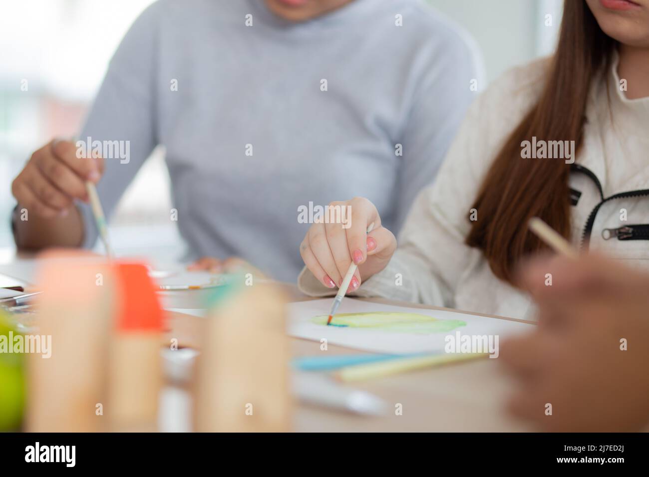 Closeup group of student sitting and studying and learning drawing with ...