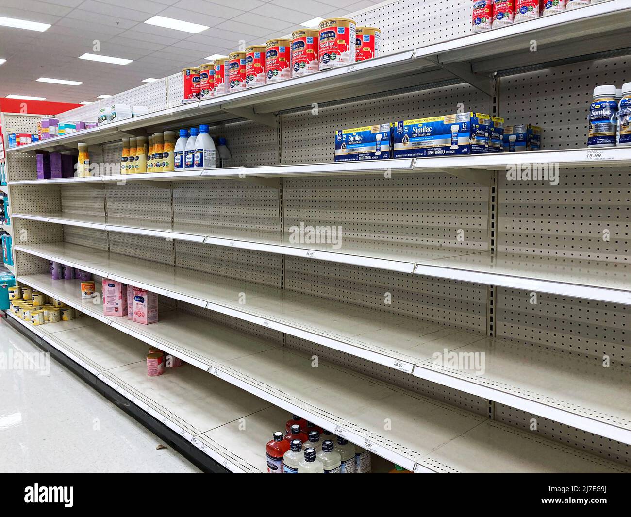 A nearly empty baby formula display shelf is seen at a Target store in ...