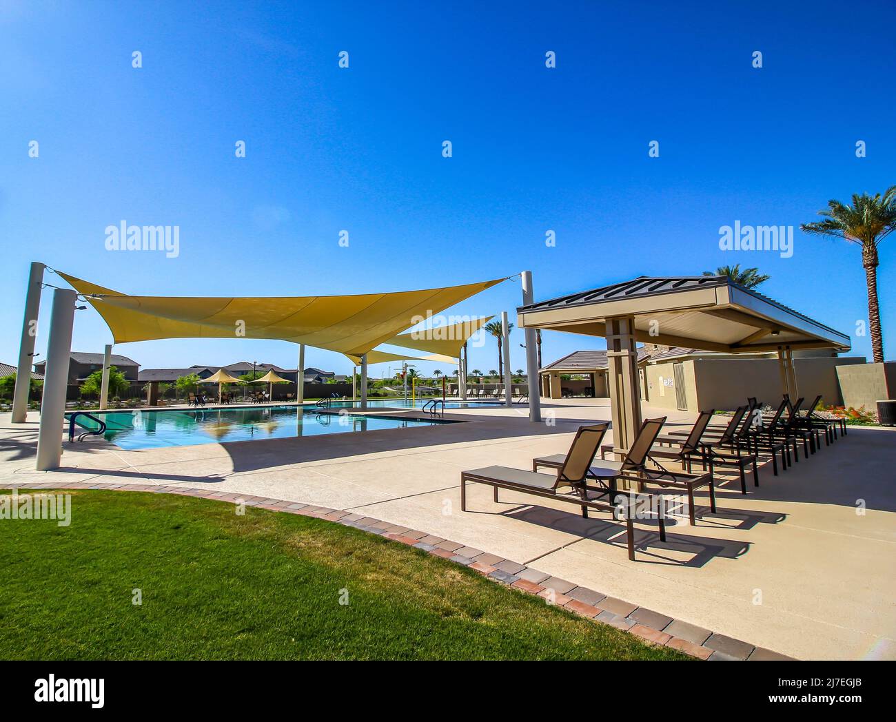 Community Swimming Pool With Shade Canopies Stock Photo - Alamy