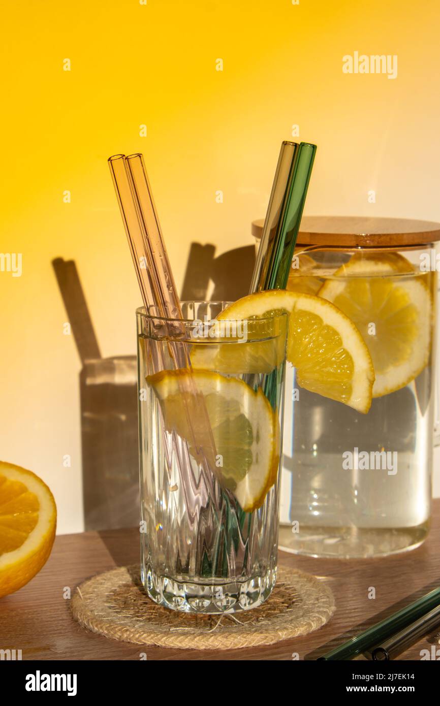 Glass of water with fresh lemon juice with Reusable glass Straws Detox cold tonic water with ...