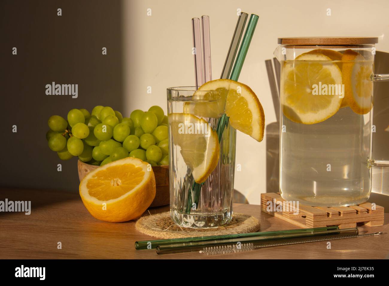 Glass of water with fresh lemon juice with Reusable glass Straws Detox cold tonic water with ...