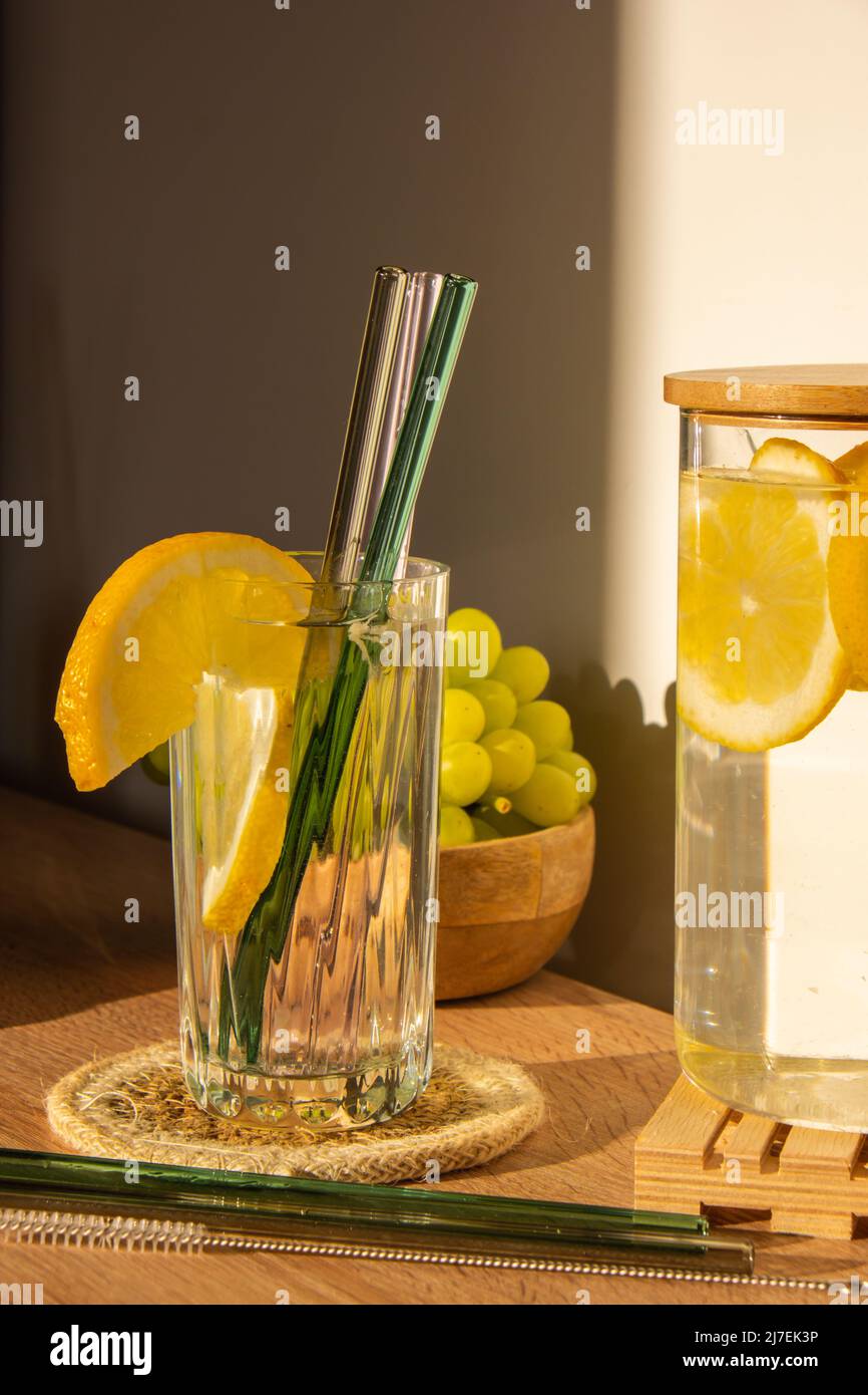 Glass of water with fresh lemon juice with Reusable glass Straws Detox cold tonic water with ...