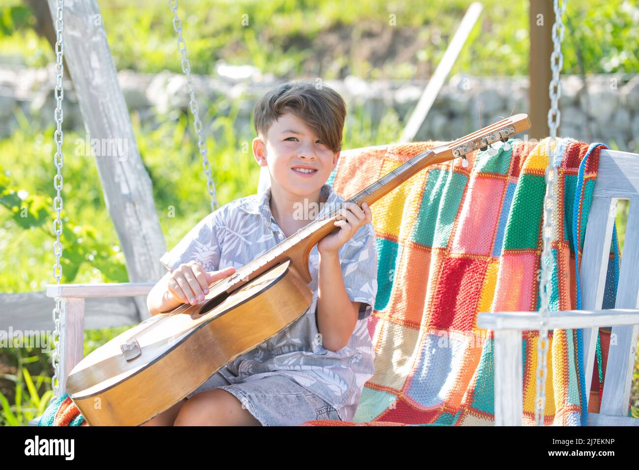 Musician child playing guitar. Kid boy singing and playing guitar ...