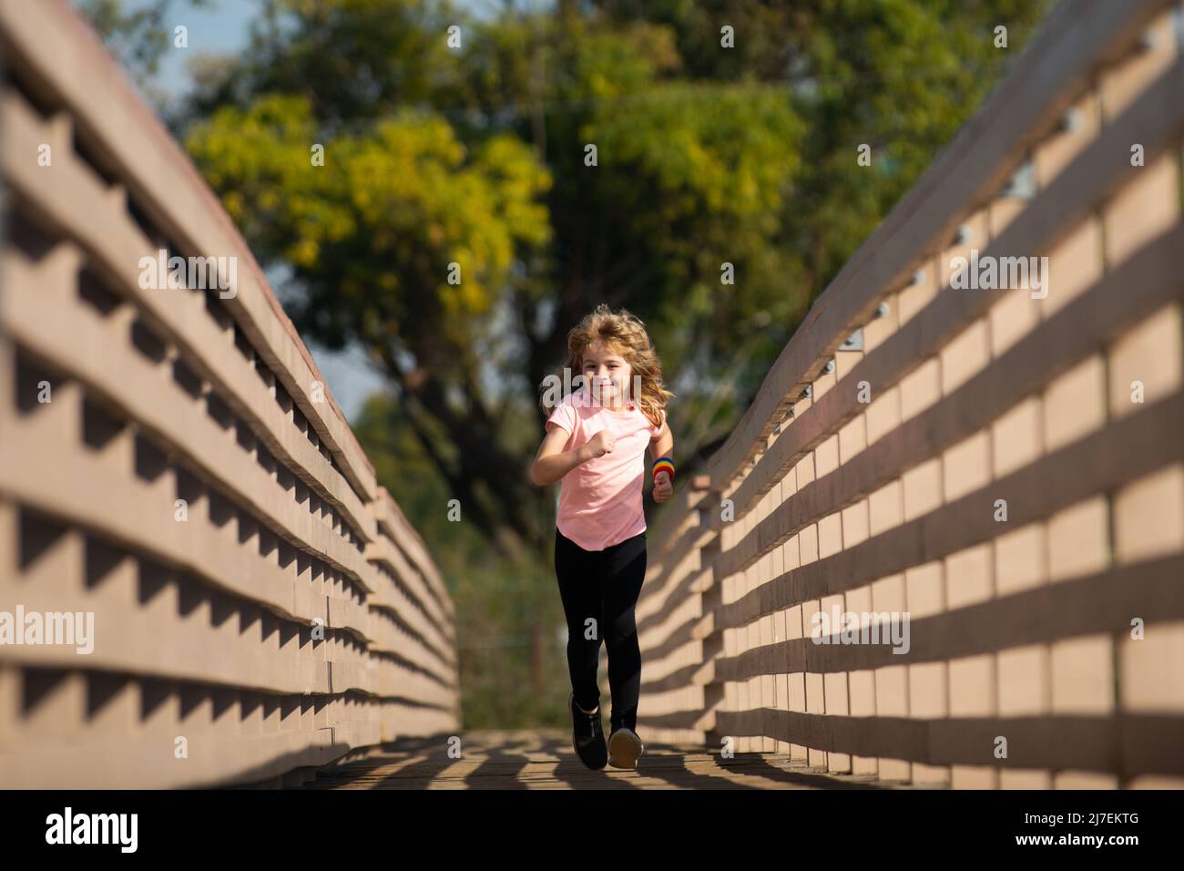 Kid runners run in park. Sporty young child jogging and training ...
