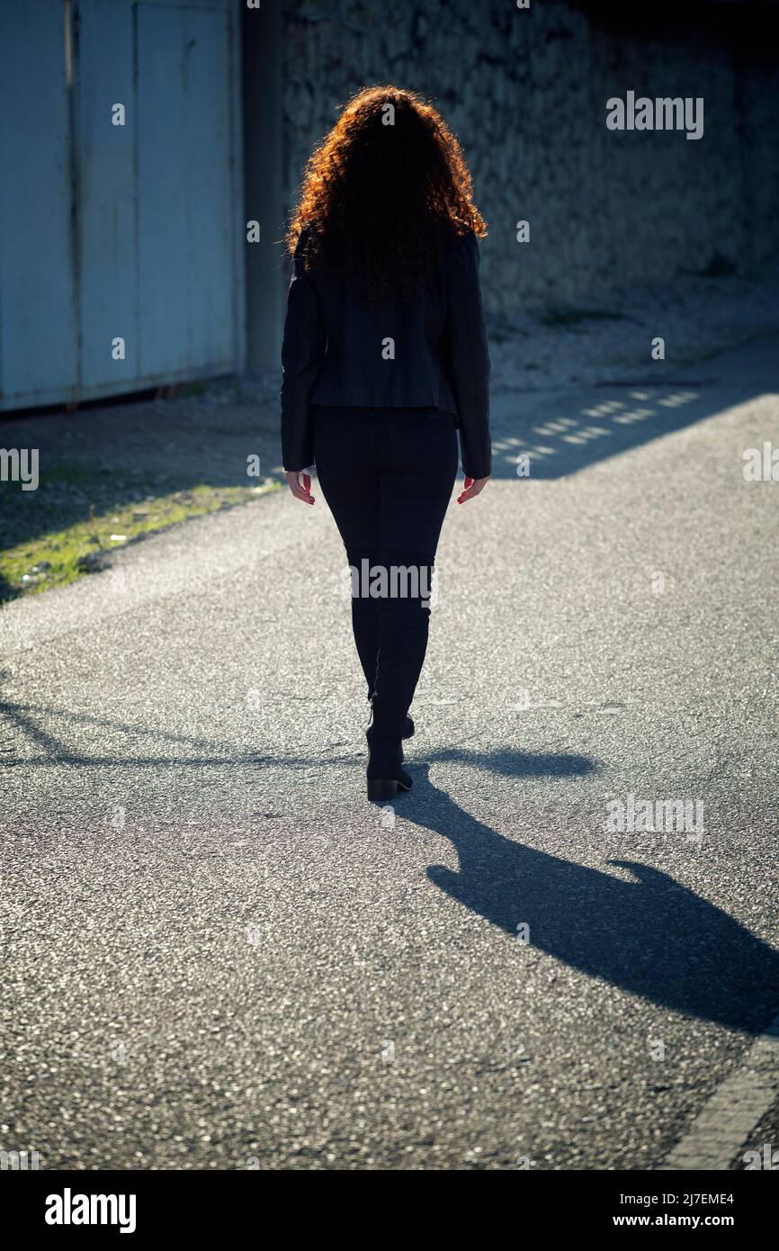 Woman walking away Stock Photo - Alamy