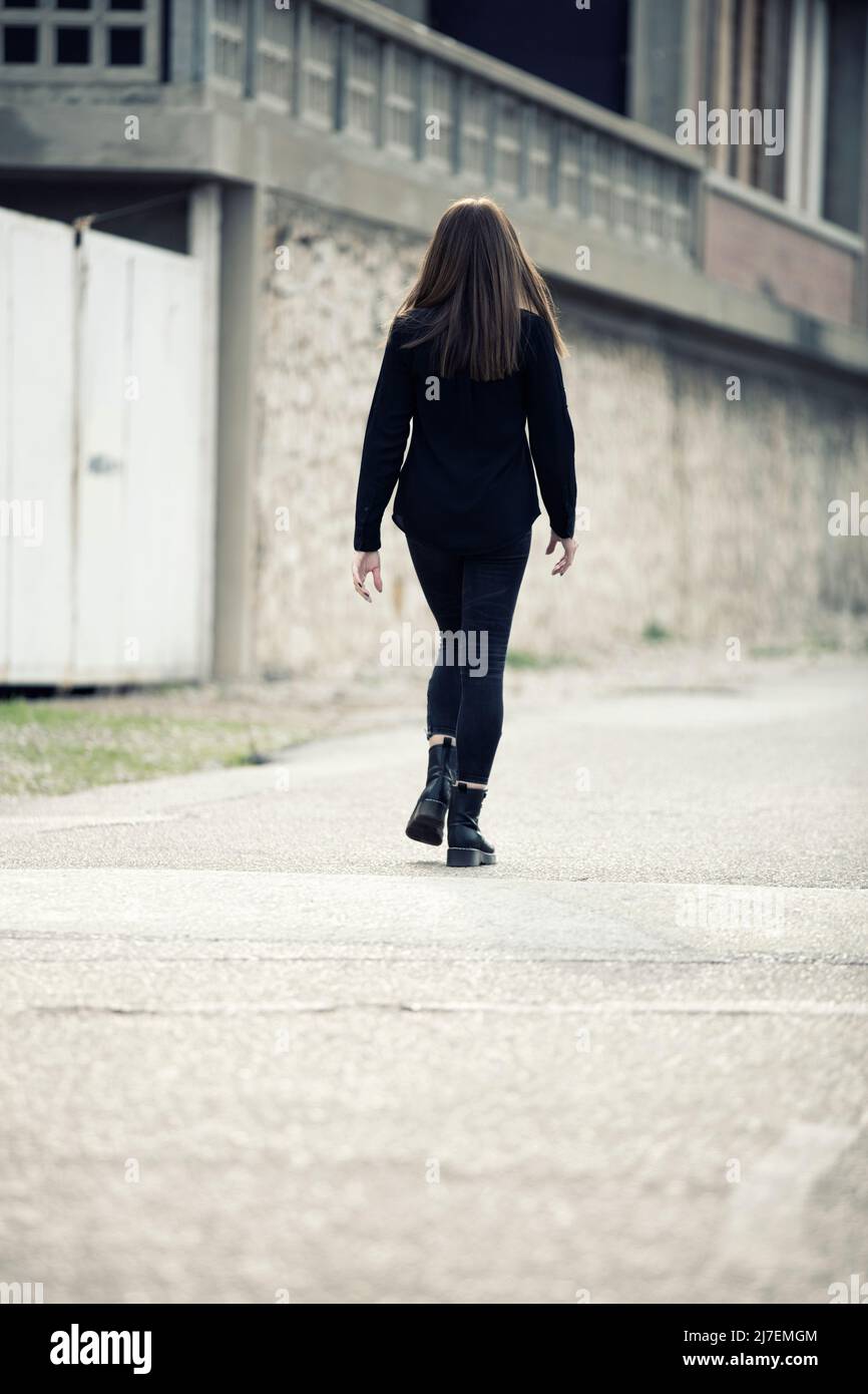 Woman walking away Stock Photo - Alamy