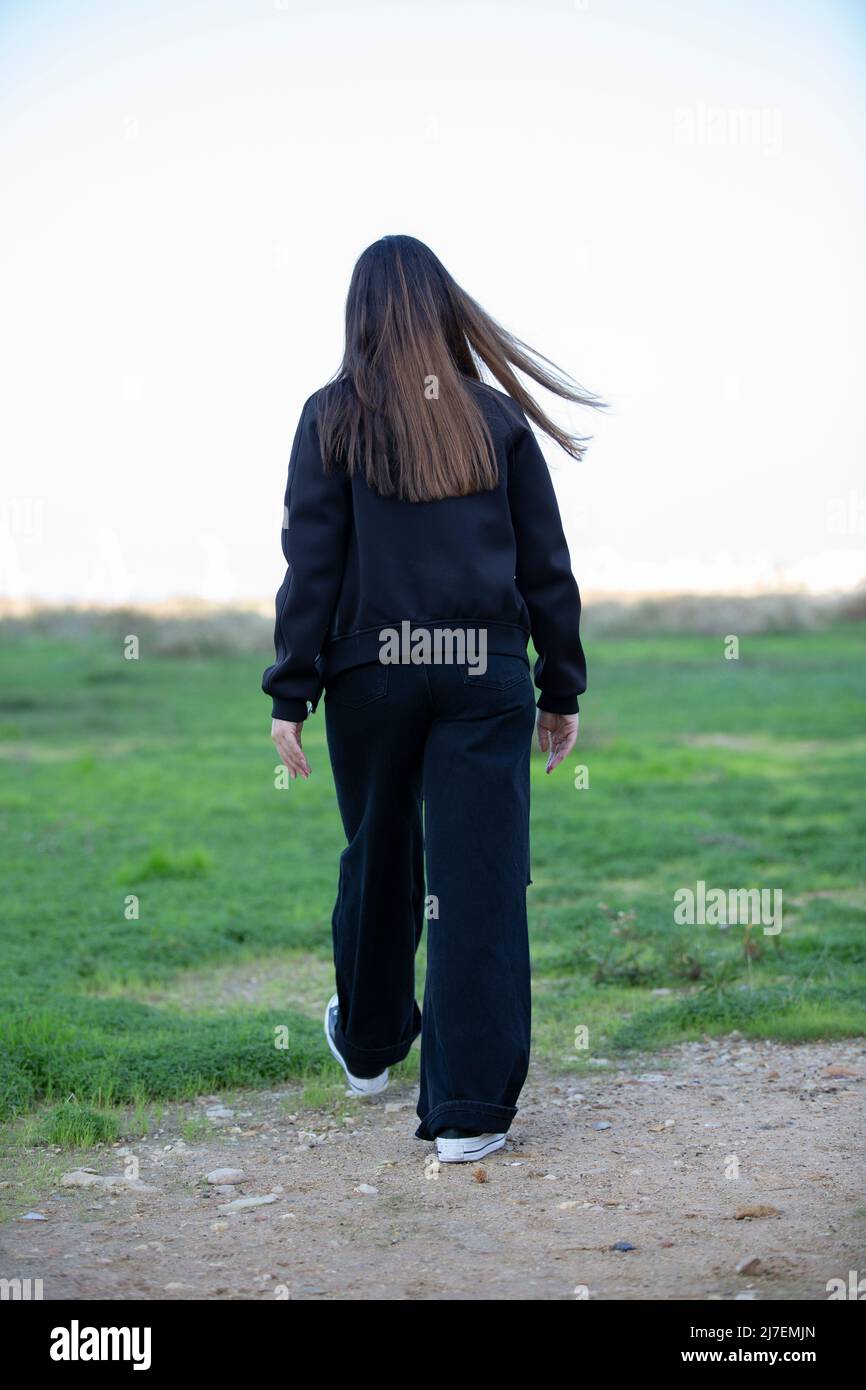 Woman walking away Stock Photo - Alamy