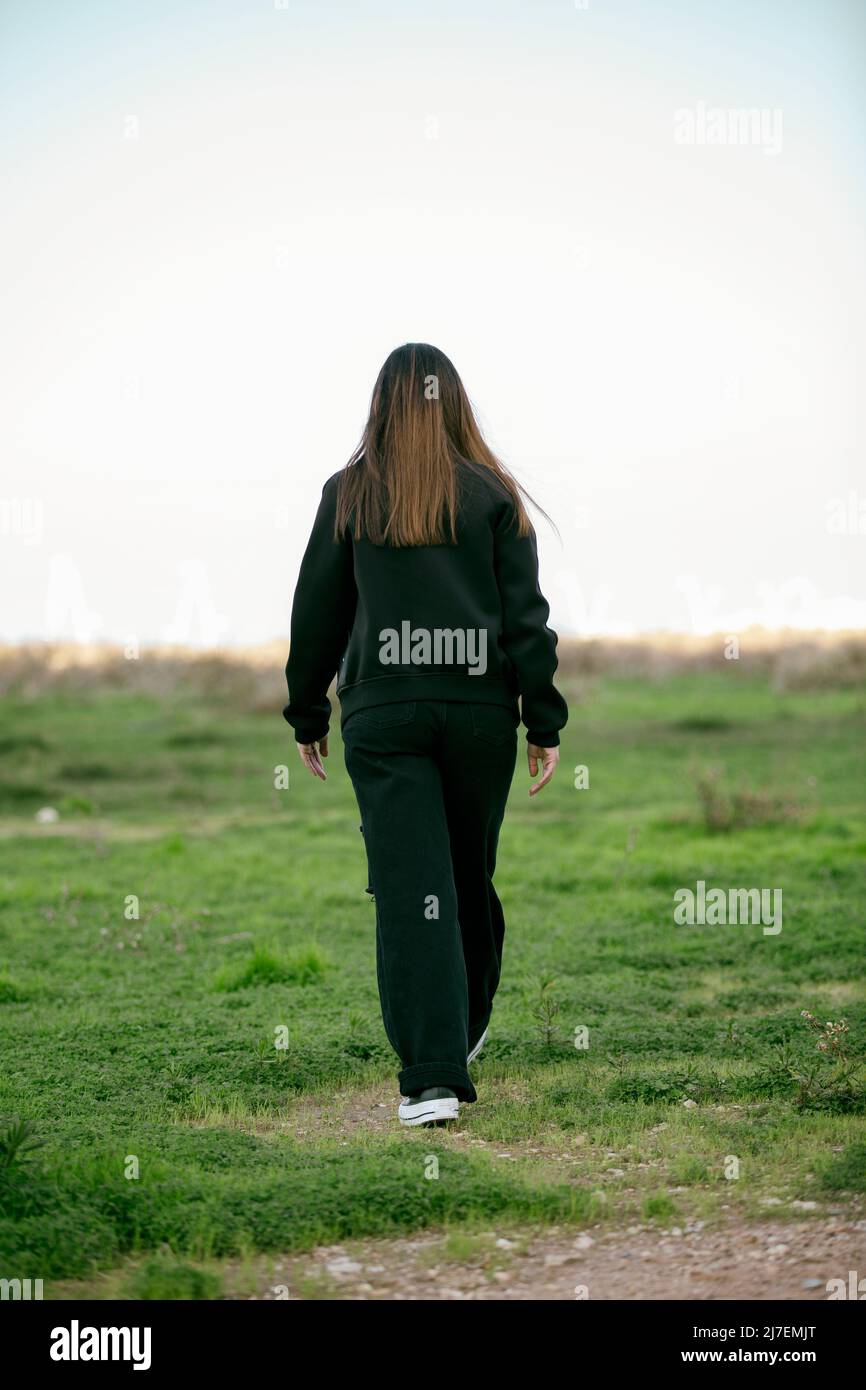 Woman walking away Stock Photo - Alamy