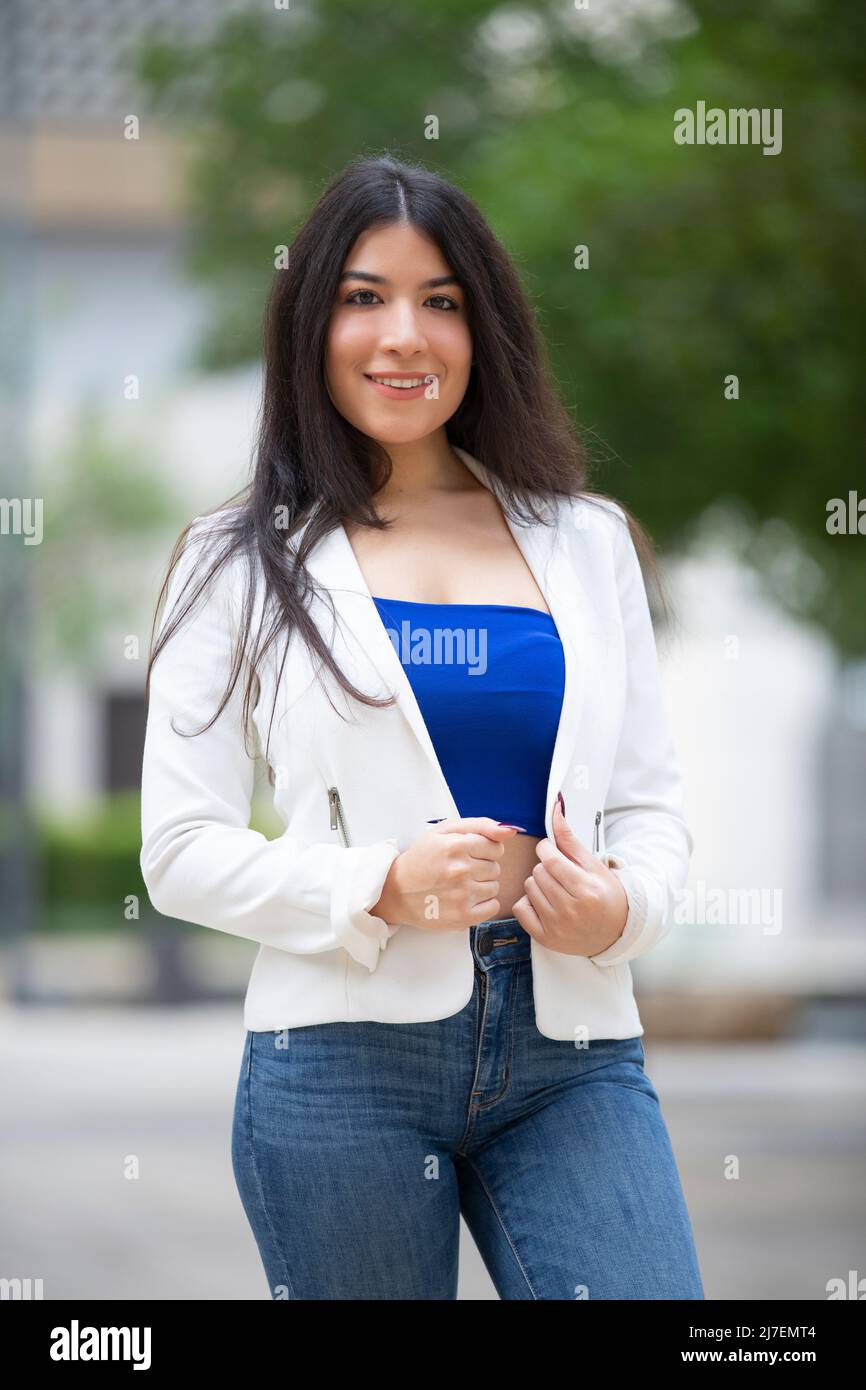 Beautiful young woman wearing blazer jacket standing outdoors Stock ...