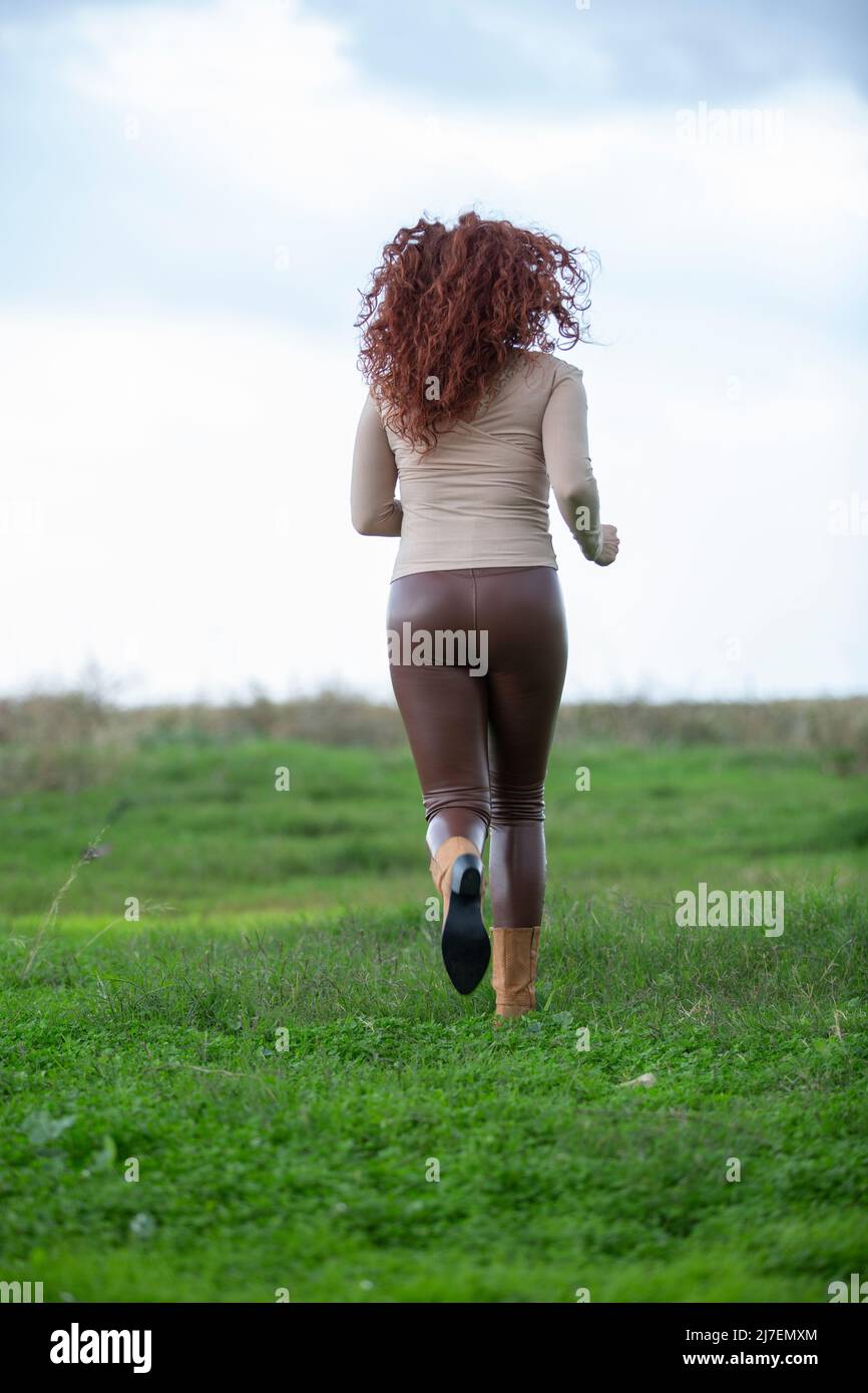 Woman running alone back view long hair hi-res stock photography and ...