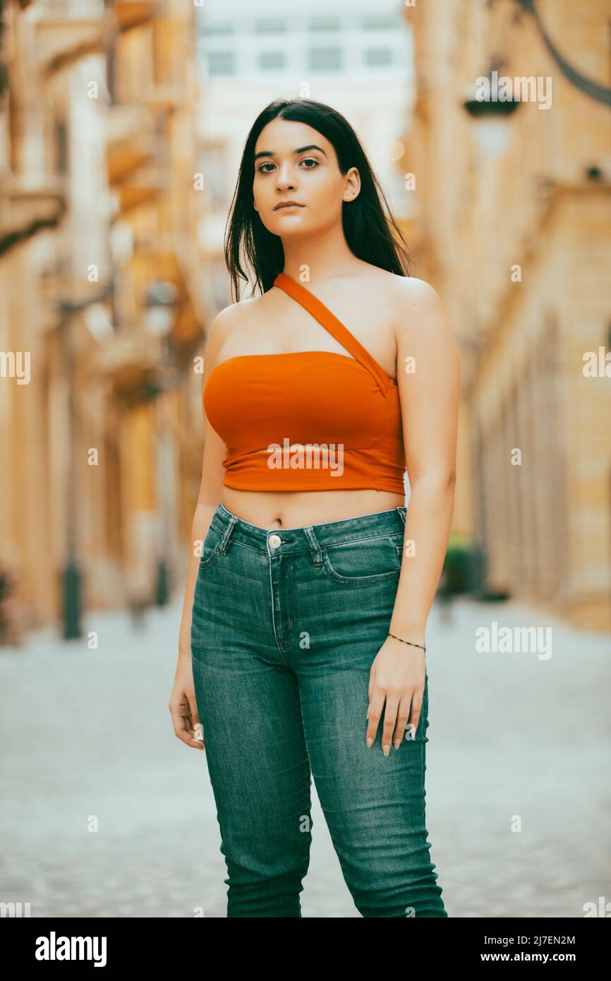 Beautiful woman standing in the street looking at camera Stock Photo ...