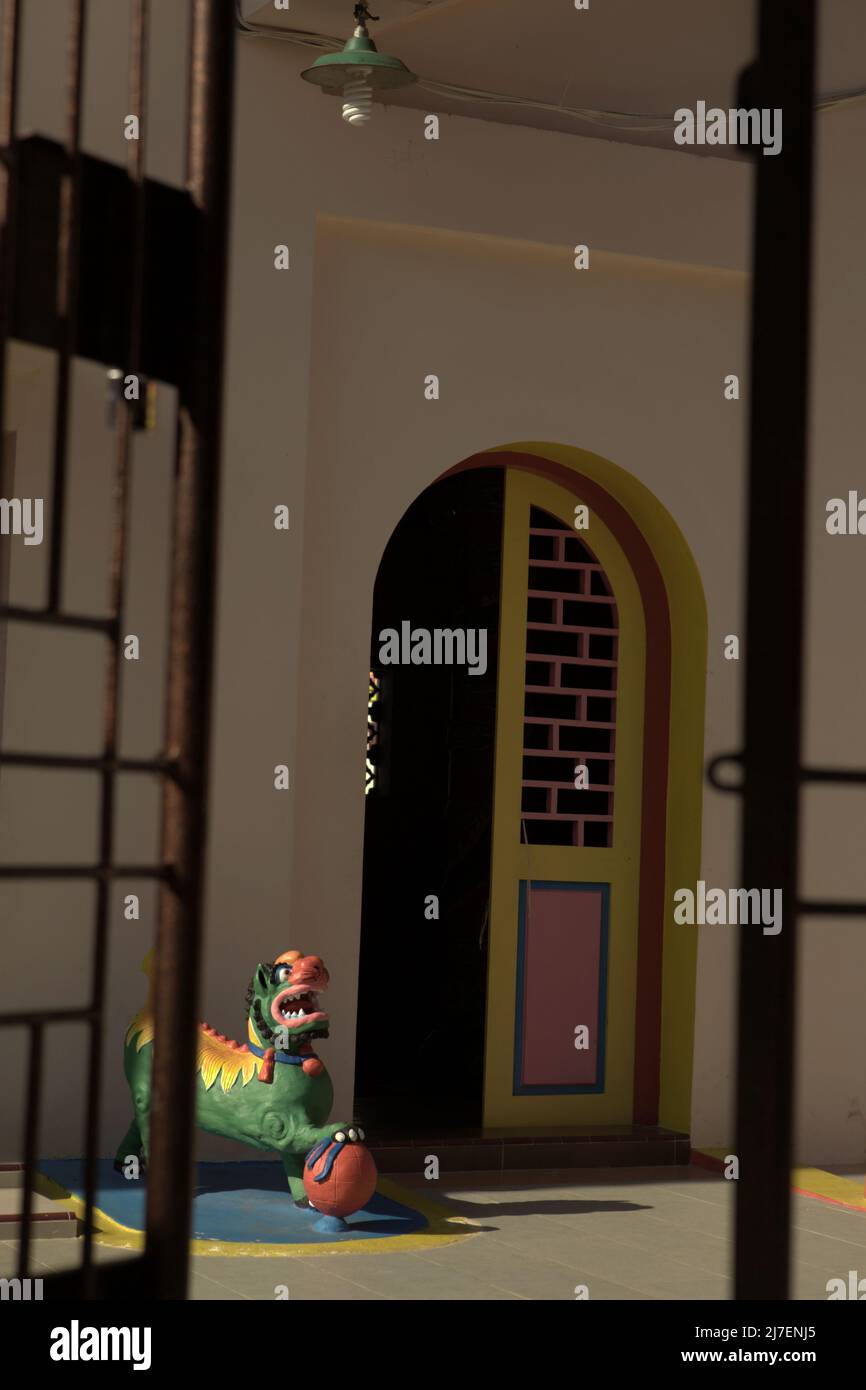 A door decorated with an animal figure holding a ball at Pulo Kemaro ...