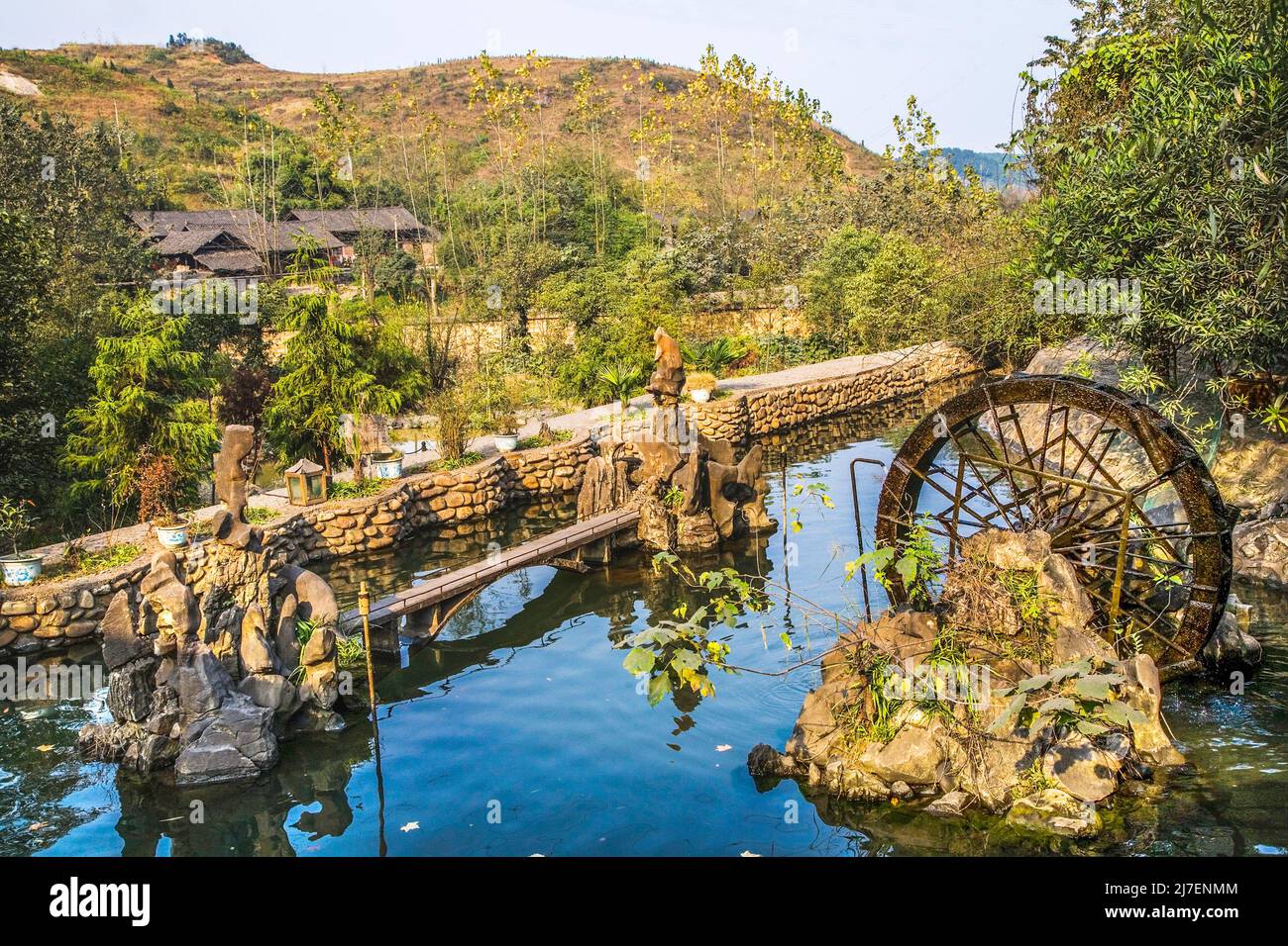 Pond and Garden with Wheel in front of village in countryside, Guizhou ...