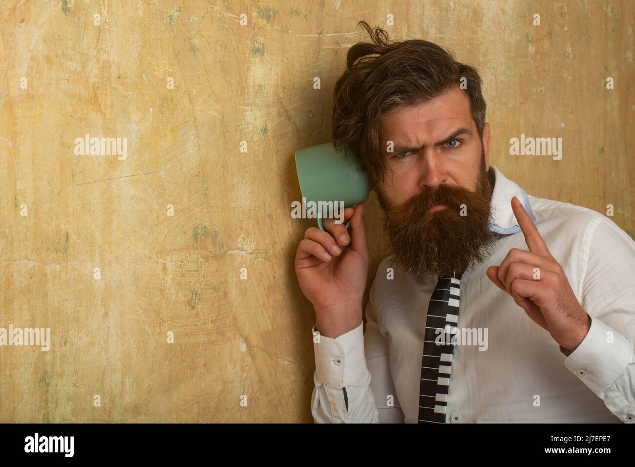 Man spying, eavesdropping. Secret and spy concept. Man eavesdrops using ...