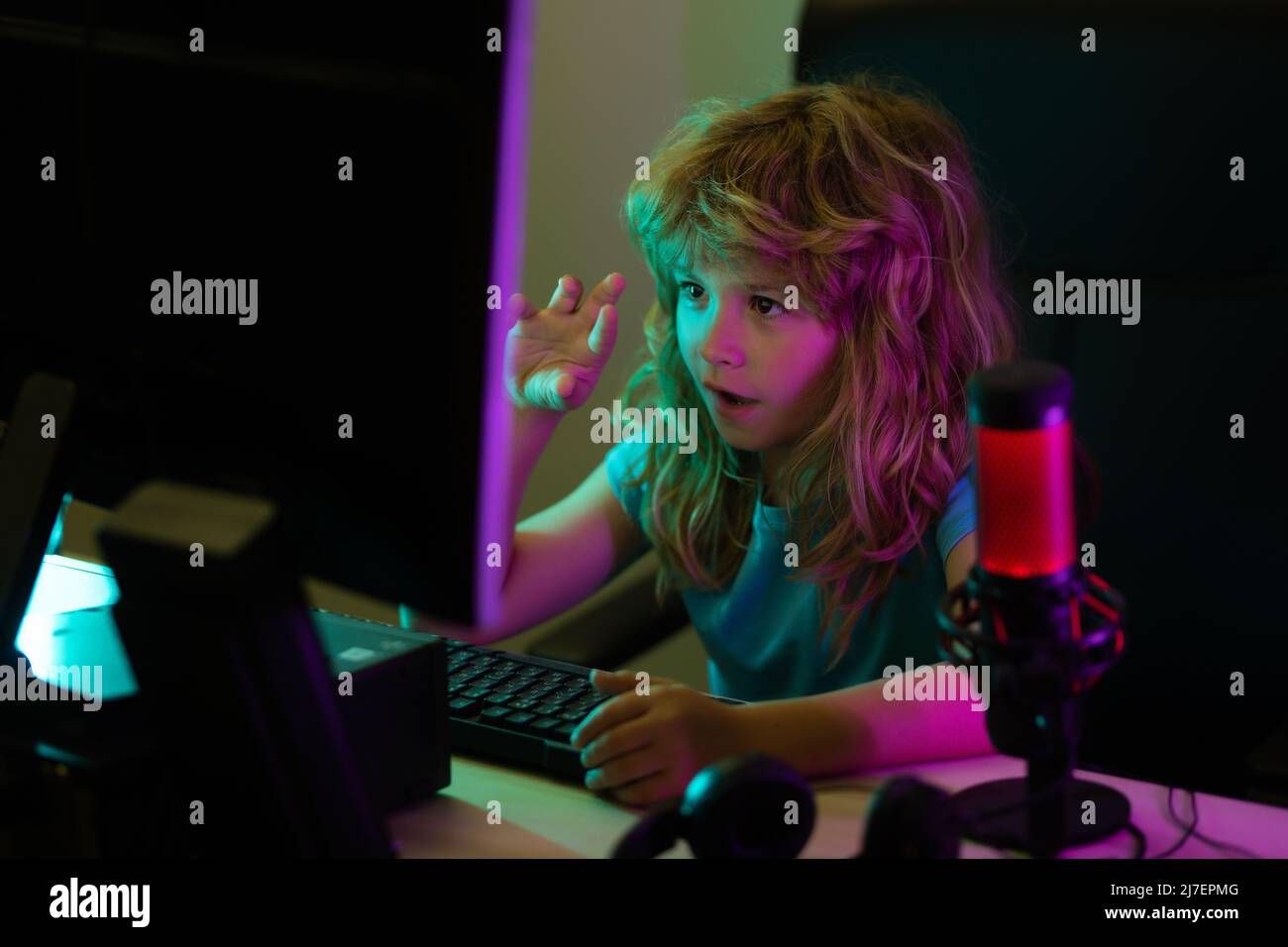 Little kid using desktop pc by night, child boy illuminated by the blue ...