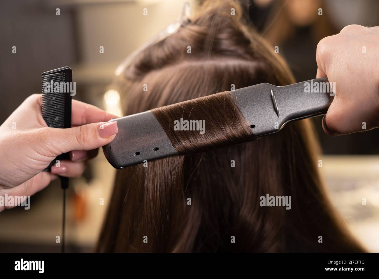 close-up of the hands of the master in the spa salon straighten the ...