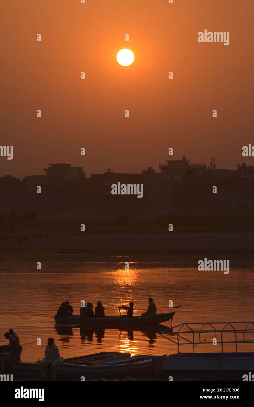 Pakistani people enjoying boating in Ravi River during sunset in Lahore. (Photo by Rana Sajid ...