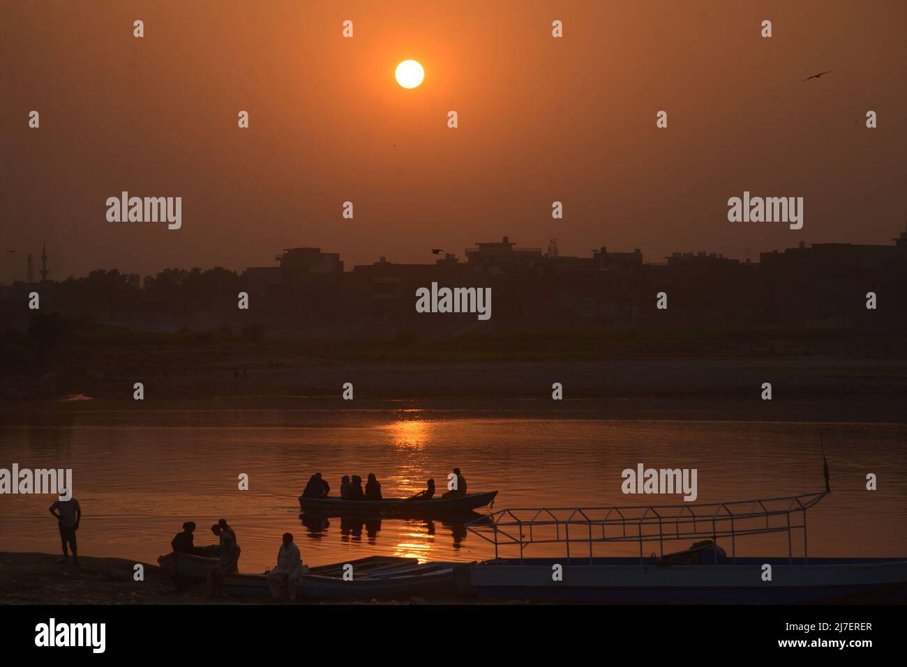 Pakistani people enjoying boating in Ravi River during sunset in Lahore. (Photo by Rana Sajid ...