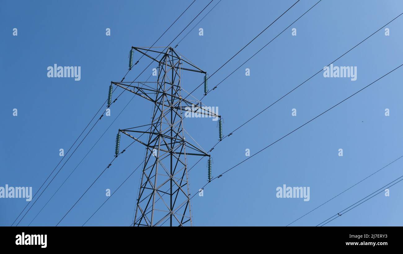 View of electricity pylon against deep blue sky with copy space Stock ...