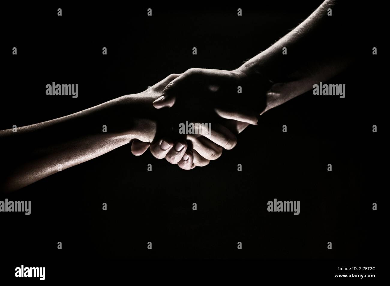 Handshake hand, arm on salvation. Close up help hand. Two hands ...