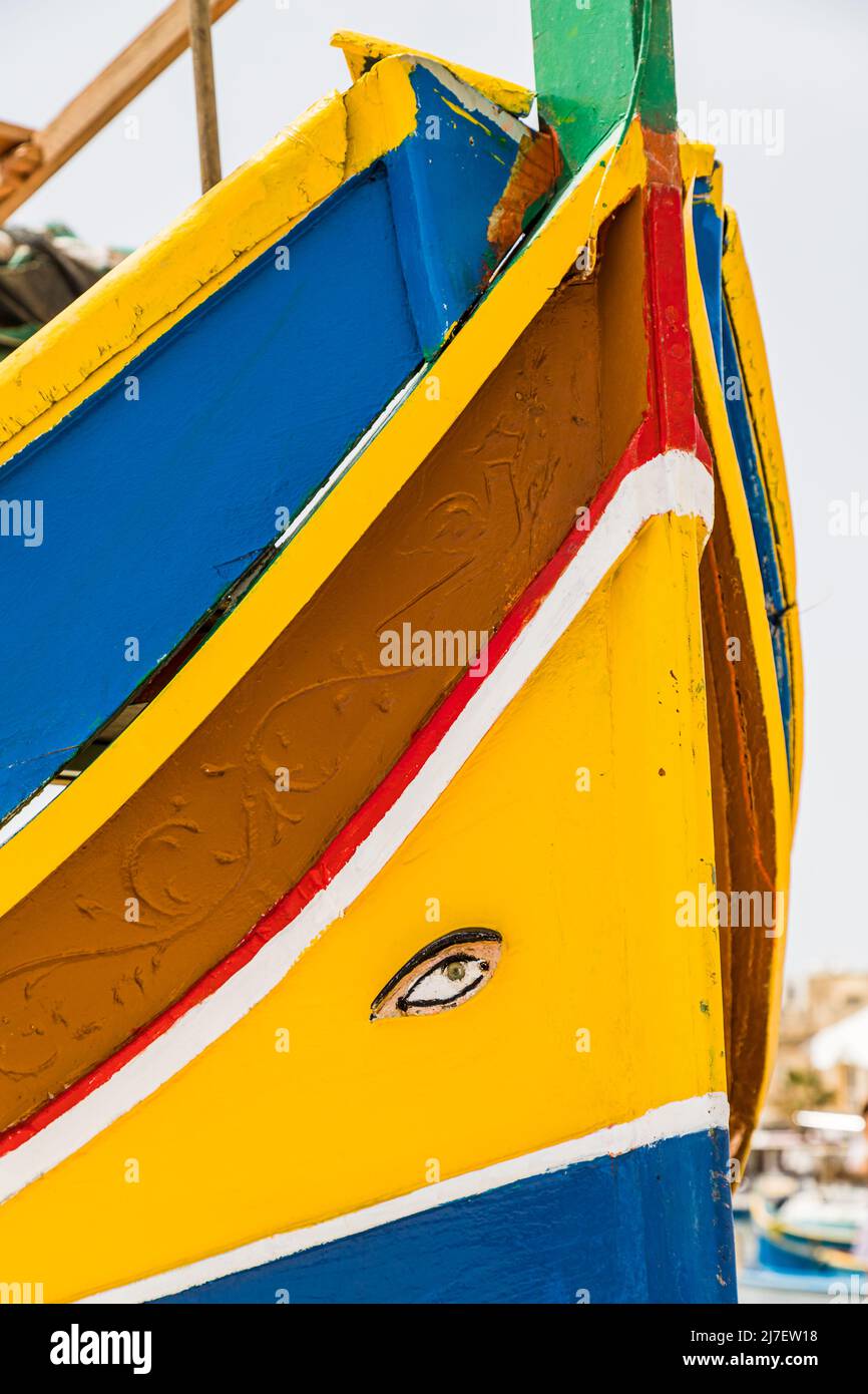 Luzzu boat up close on the shore of Marsaxlokk harbour in Malta seen in ...