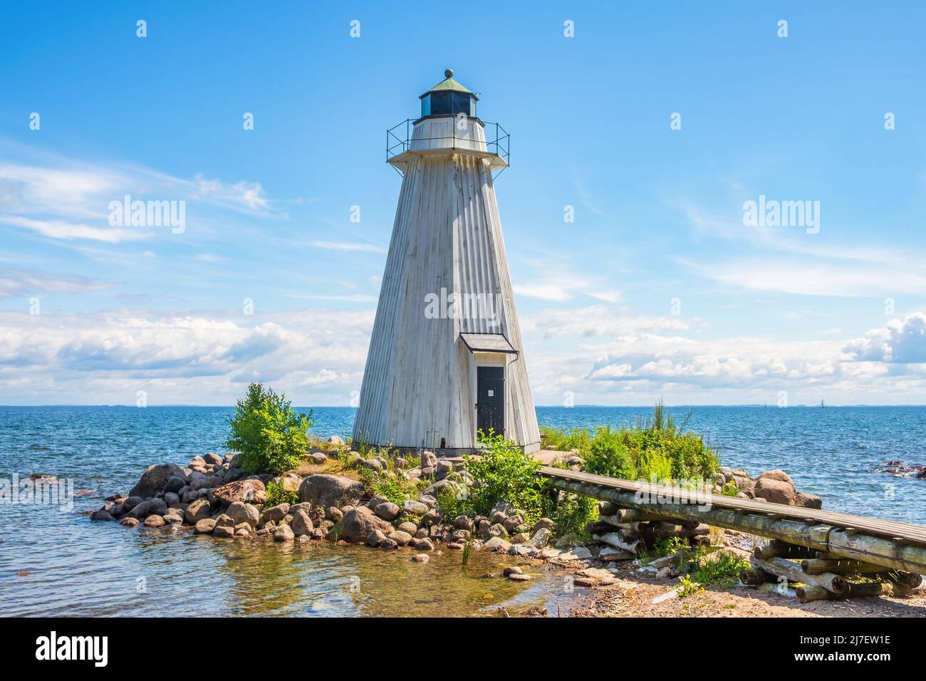 Lake view with a wooden lighthouse on an island Stock Photo - Alamy