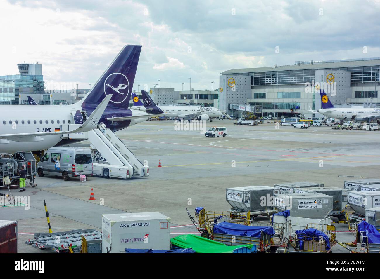 Airport area with planes and work vehicles Stock Photo - Alamy
