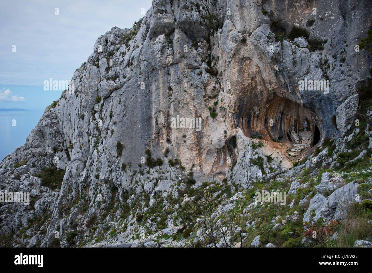 A cave in the rock with the sanctuary of the Mother of God Stock Photo ...