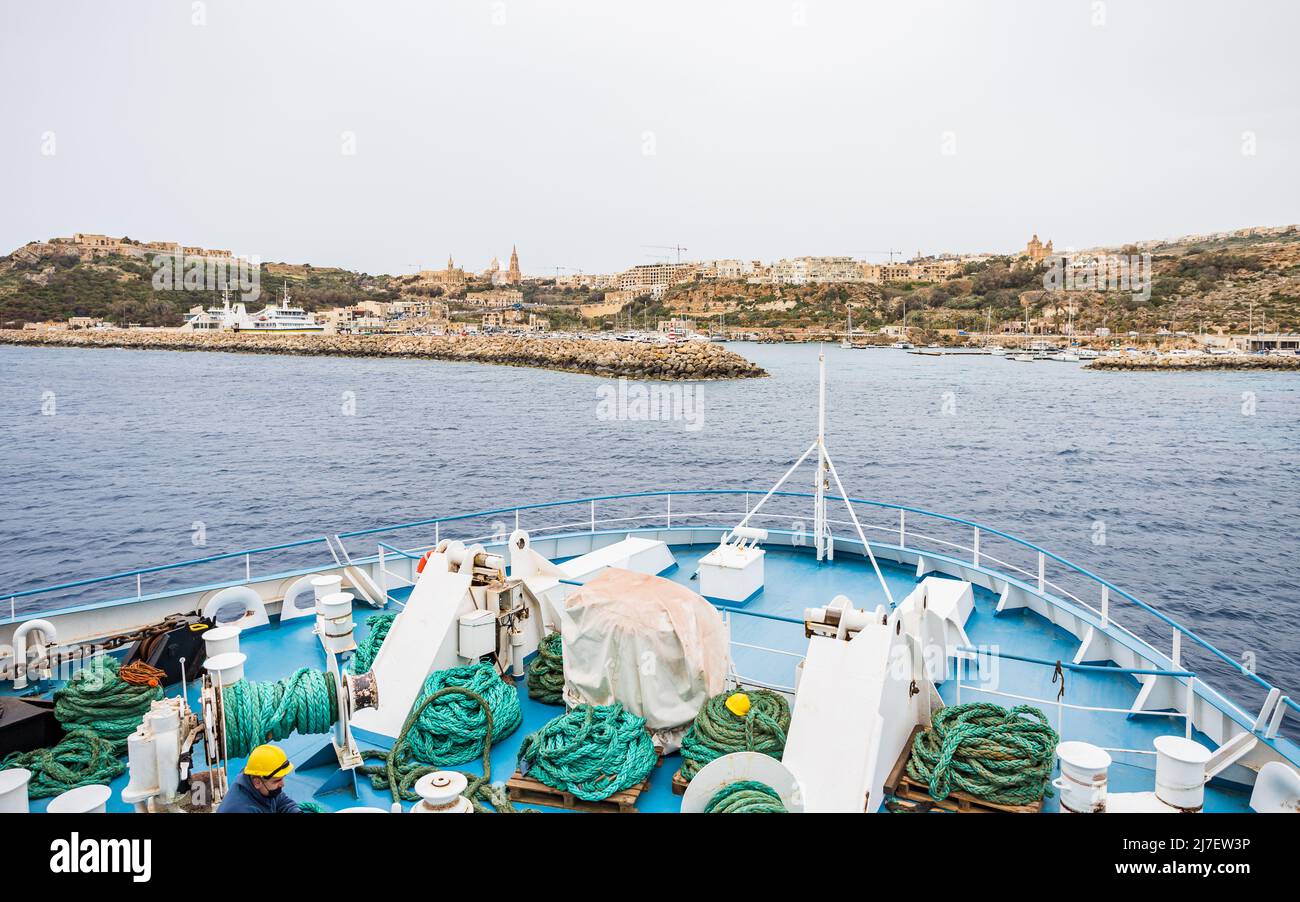 Car ferry approaches Mgarr harbour during an overcast day in April 2022 ...