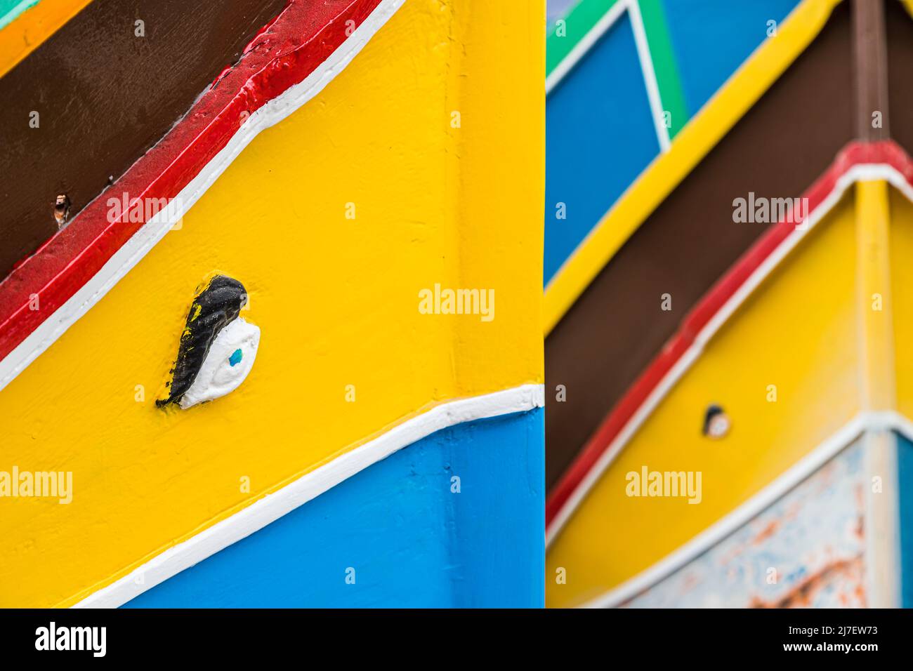 A pair of Luzzu boats fill the frame with colour at Mgarr harbour on ...