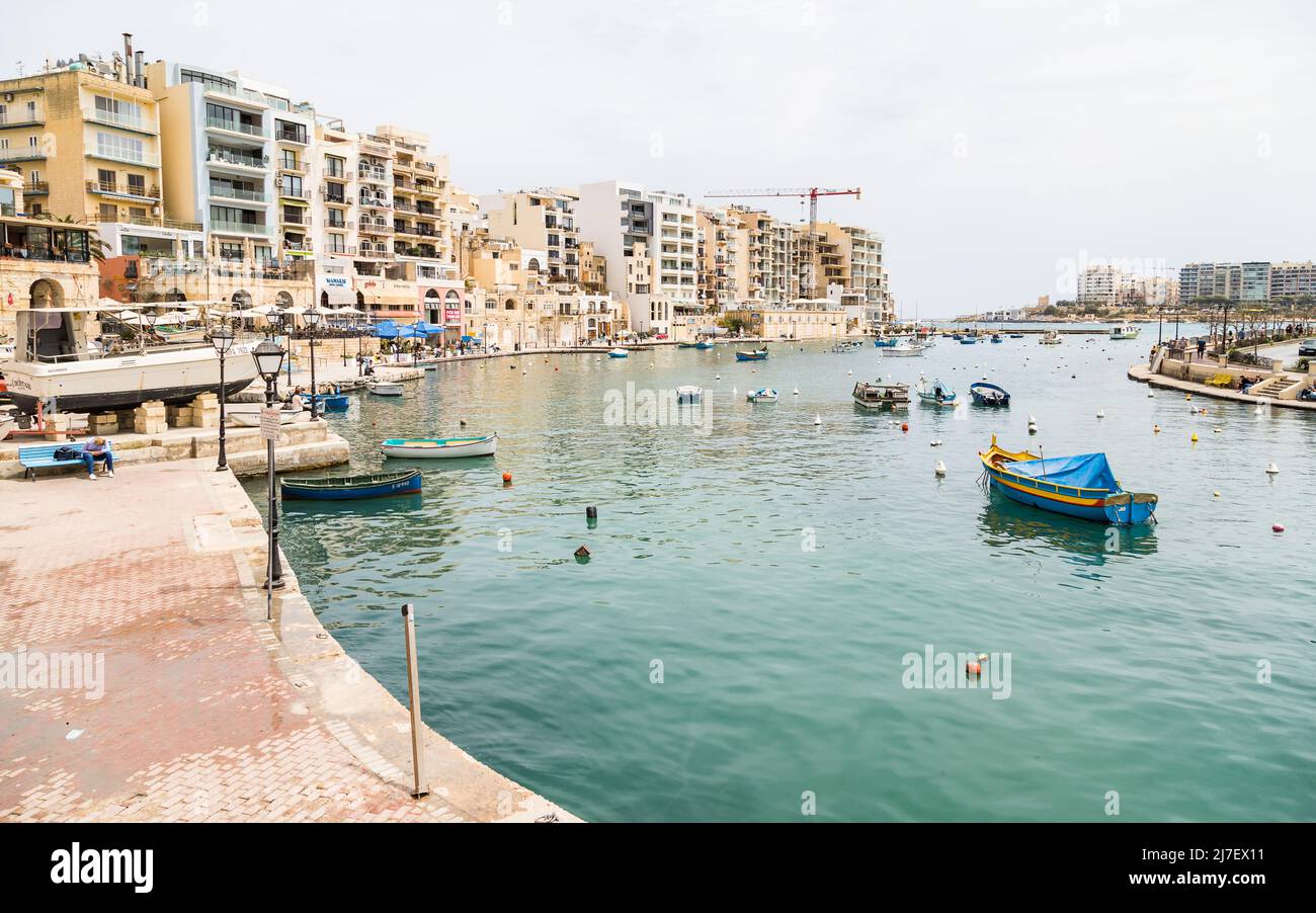 Looking out of Spinola Bay full of boats and surrounded by hotels, seen ...