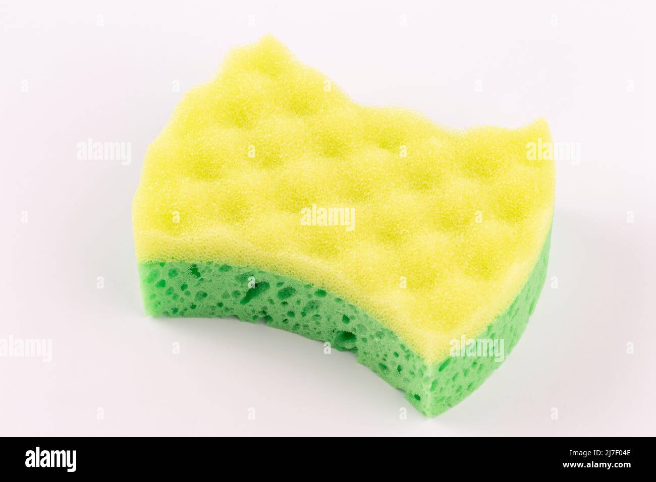 Yellow- green sponge for washing dishes close-up isolated on white ...
