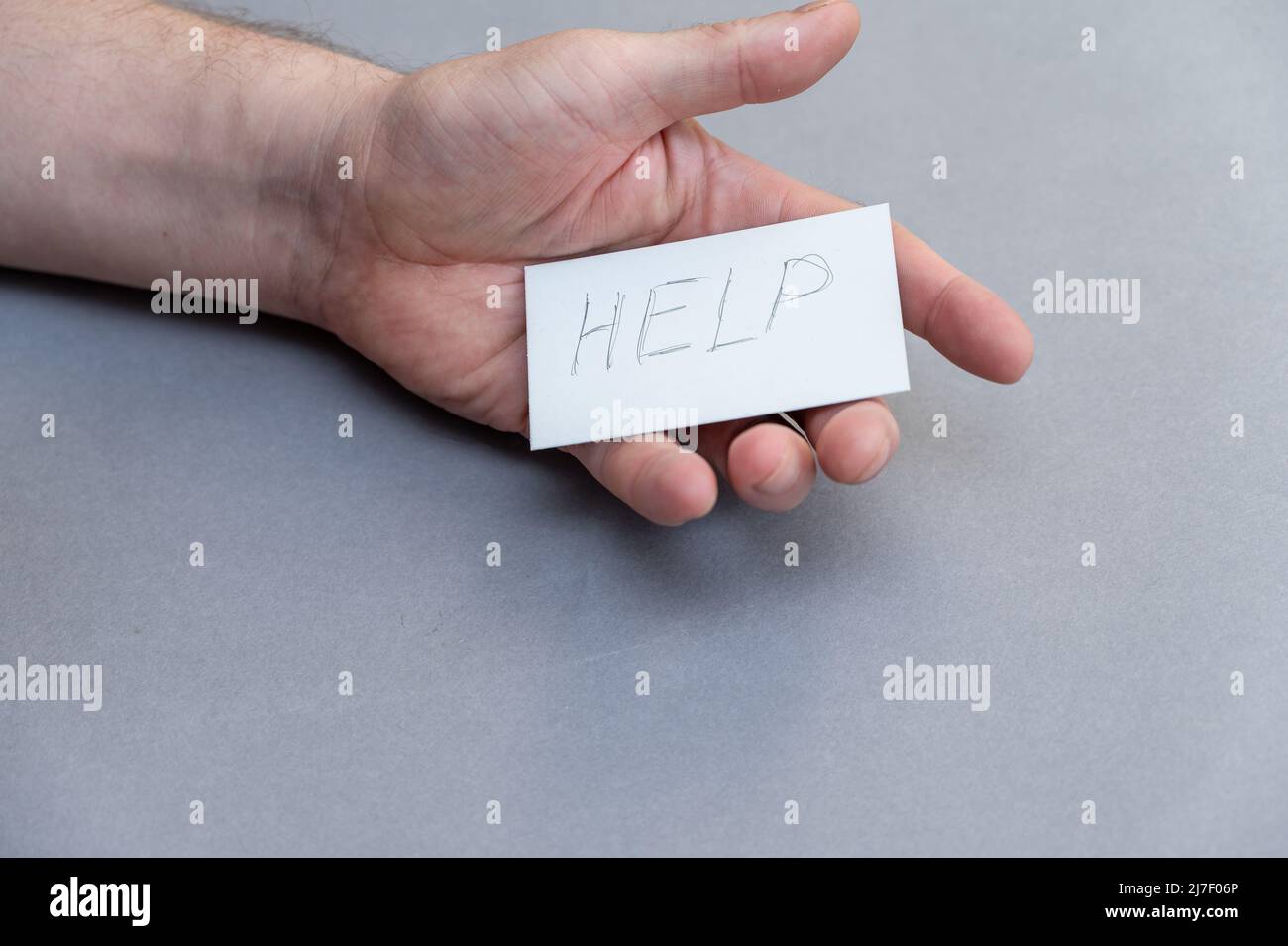 Help. Handwritten gray lettering. Open male palm with white business ...