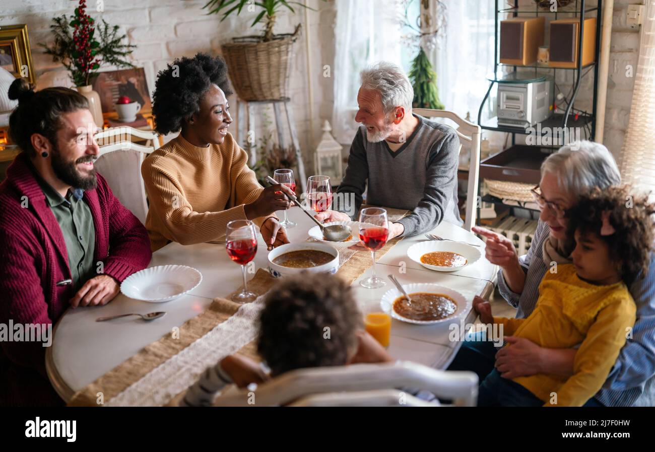 Happy multiethnic multigeneration family having fun together around ...