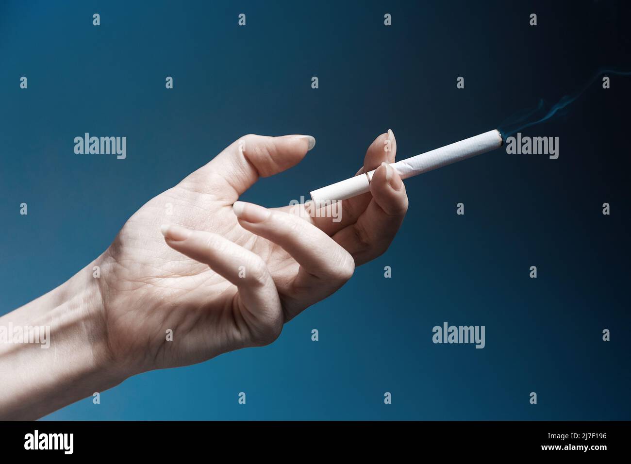World No Tabacco day. A pale, crooked female hand, close-up, holding a ...