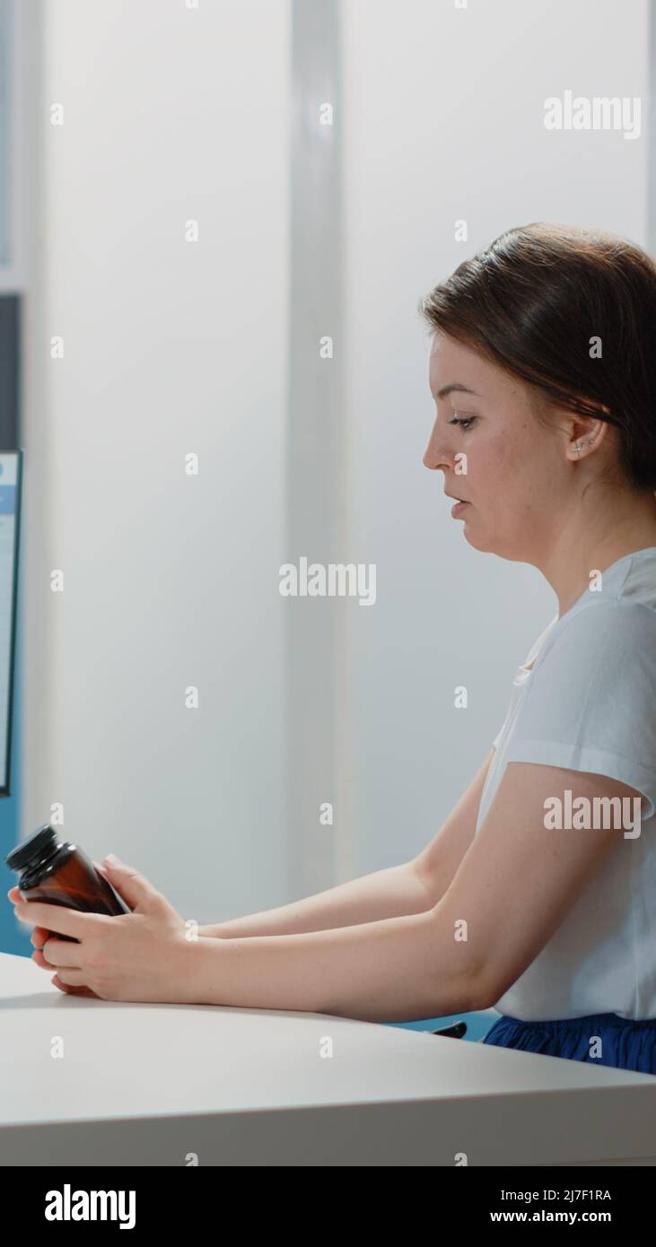 Specialist giving bottle of pills to woman for prescription treatment ...