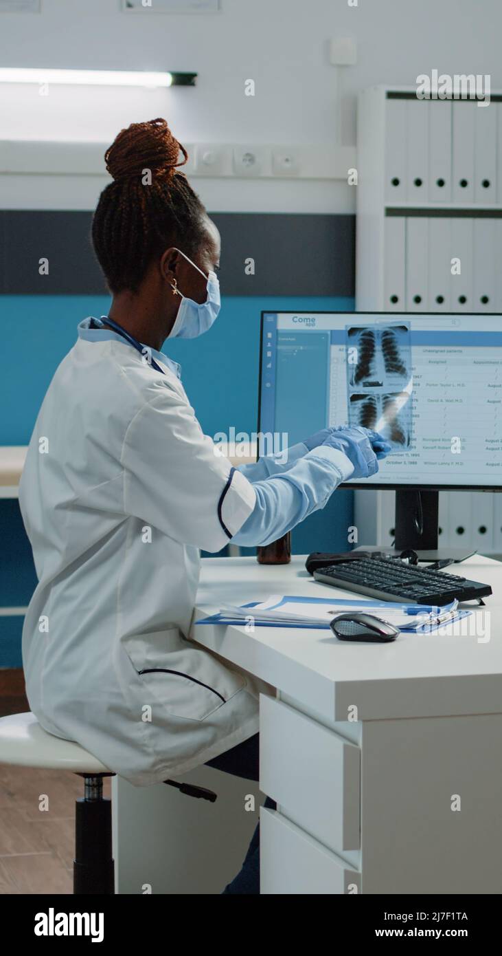 Medic holding radiography for examination with patient during ...