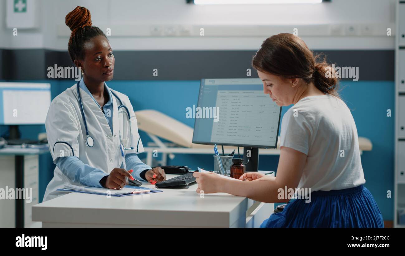Patient receiving medical treatment from doctor at checkup visit. Medic ...