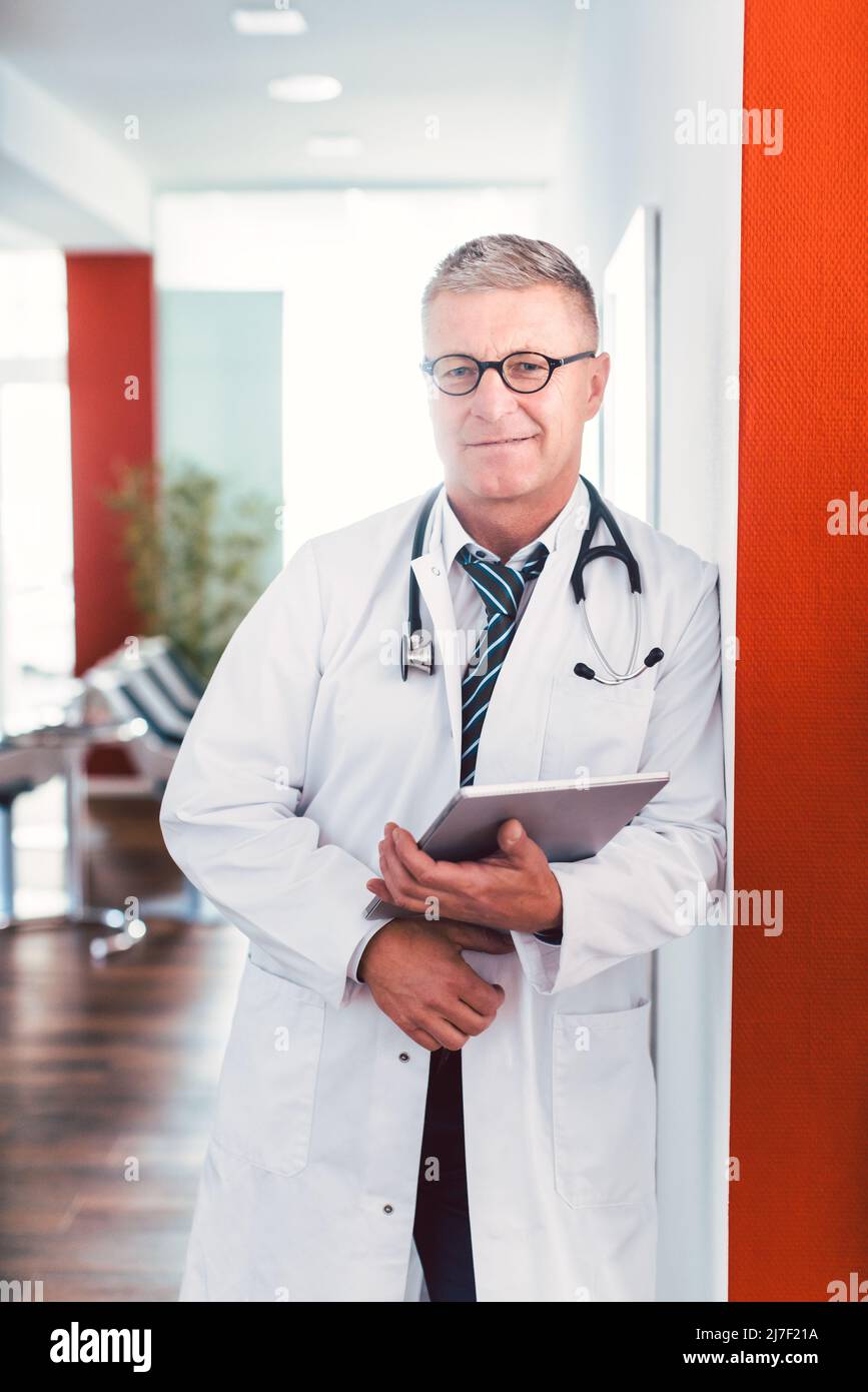 Doctor standing in his practice Stock Photo - Alamy