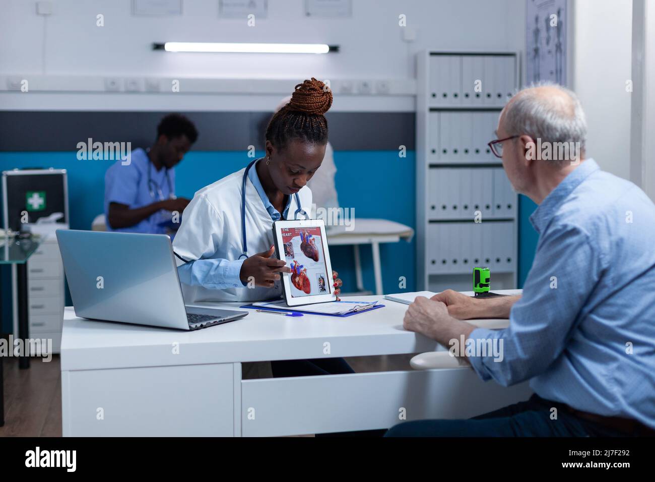 Clinic healthcare cardiology specialist examining senior patient heart ...