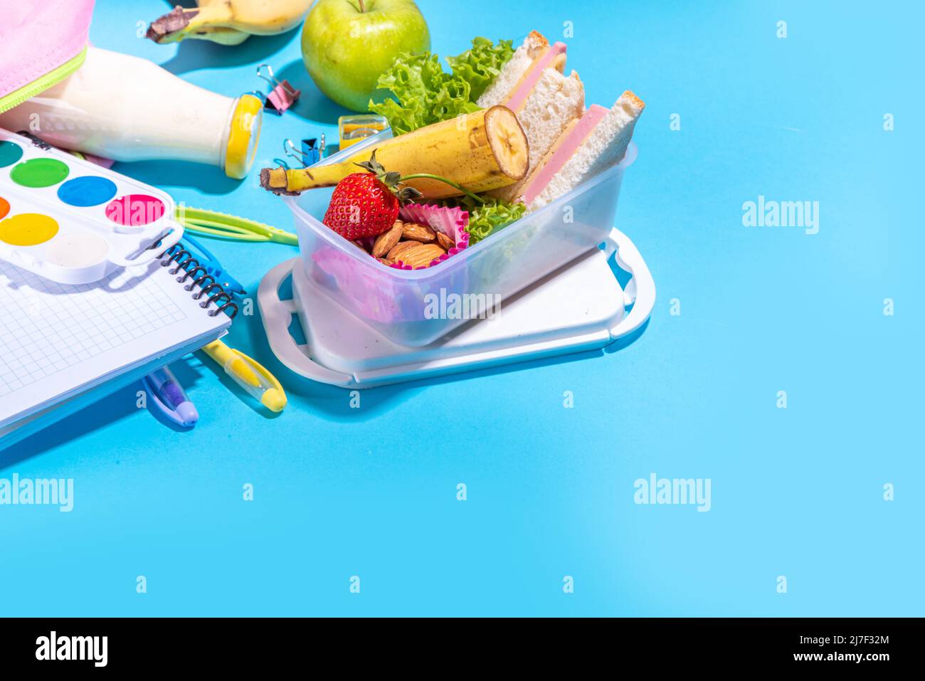 Healthy school lunch box: sandwich, vegetables, fruit, nuts and yogurt ...