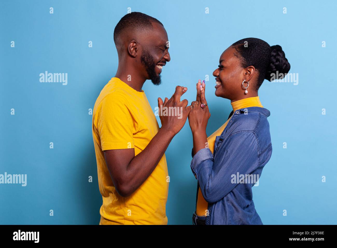 Couple holding fingers crossed to wish for good luck and fortune in ...