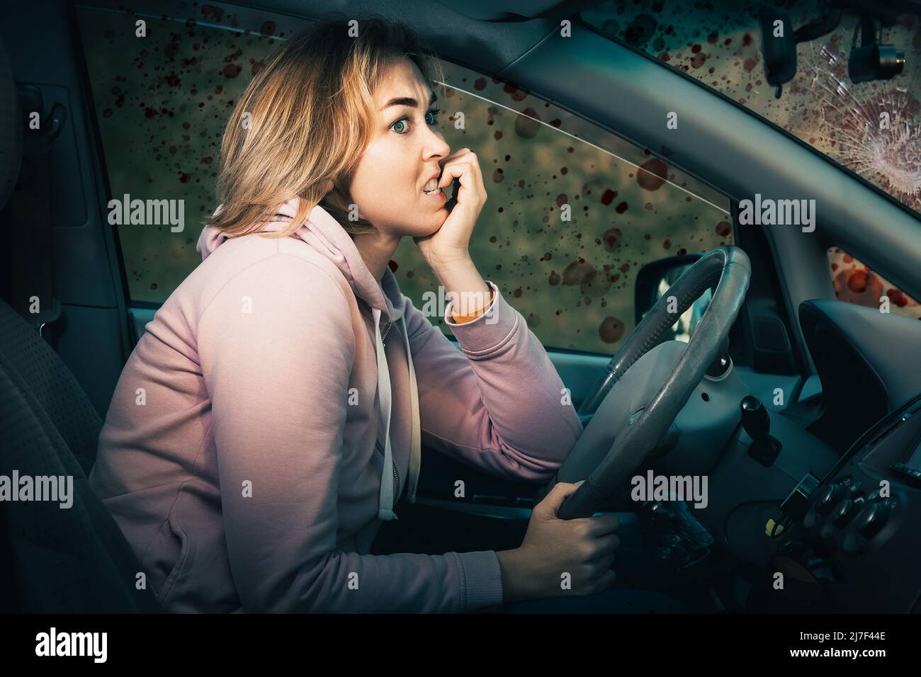 Traffic accident. A scared young blonde nervous woman is sitting behind ...