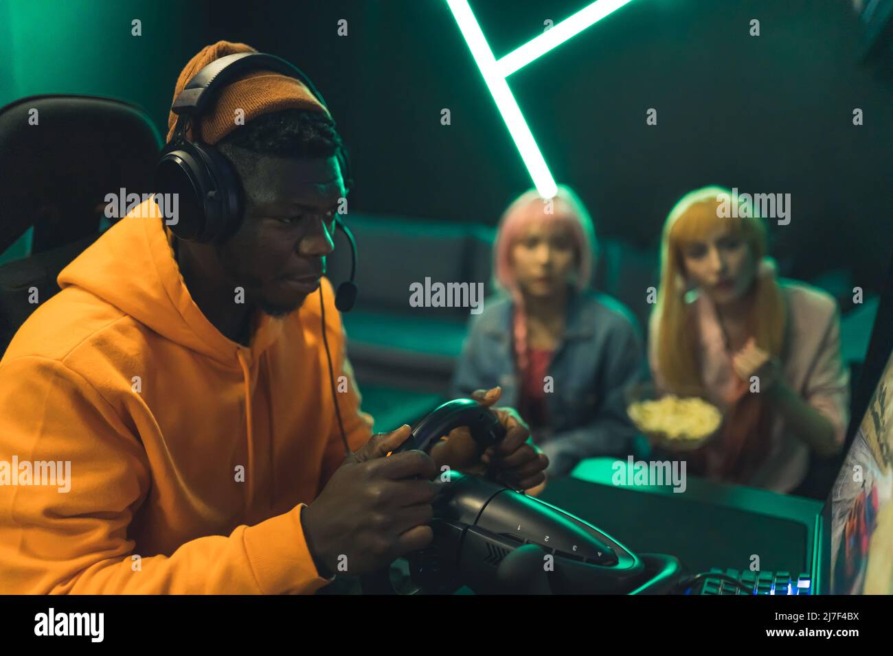 Afro-American male gamer with headset participating in tournament ...