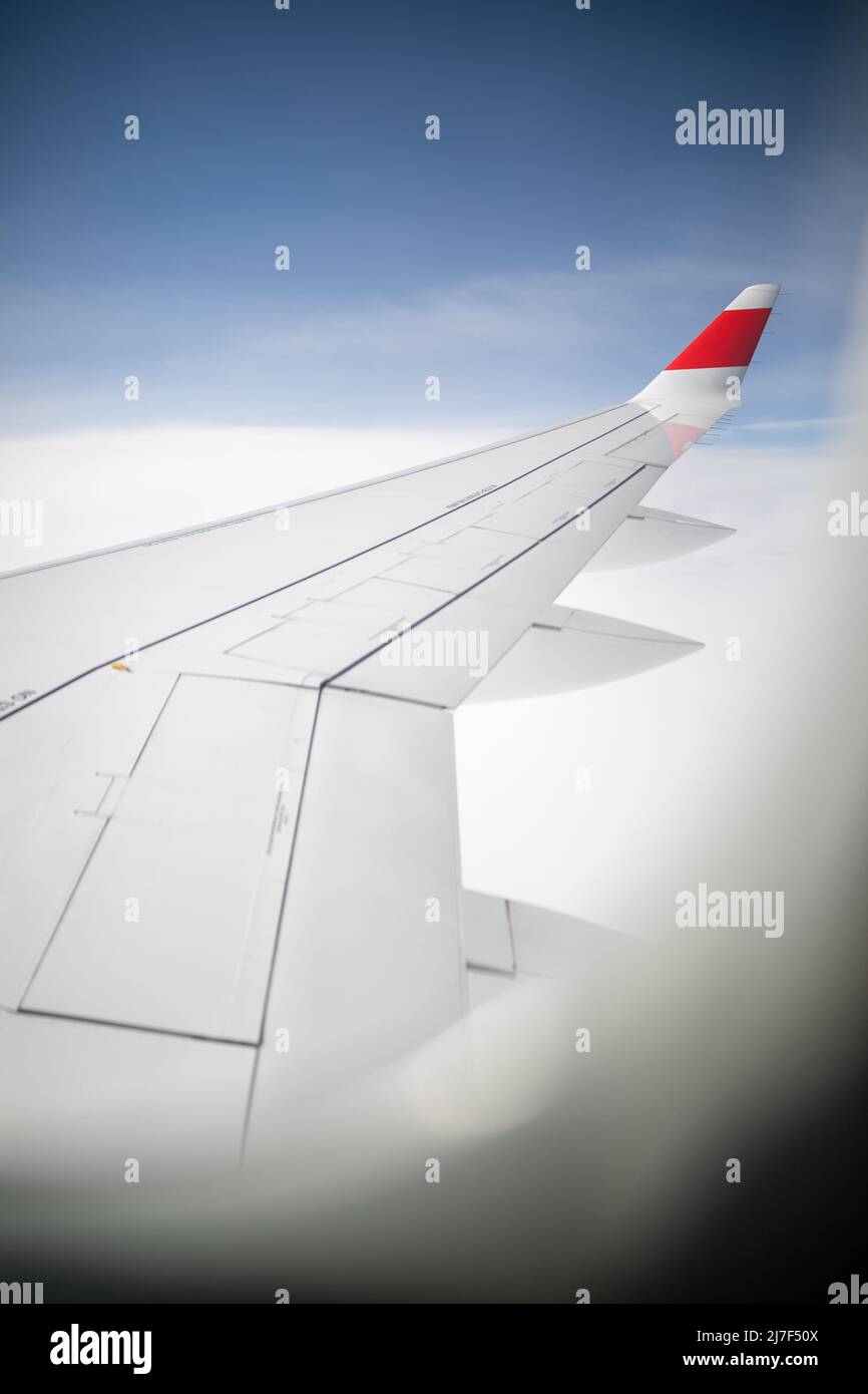 Modern commercial aircraft wing through window Stock Photo - Alamy